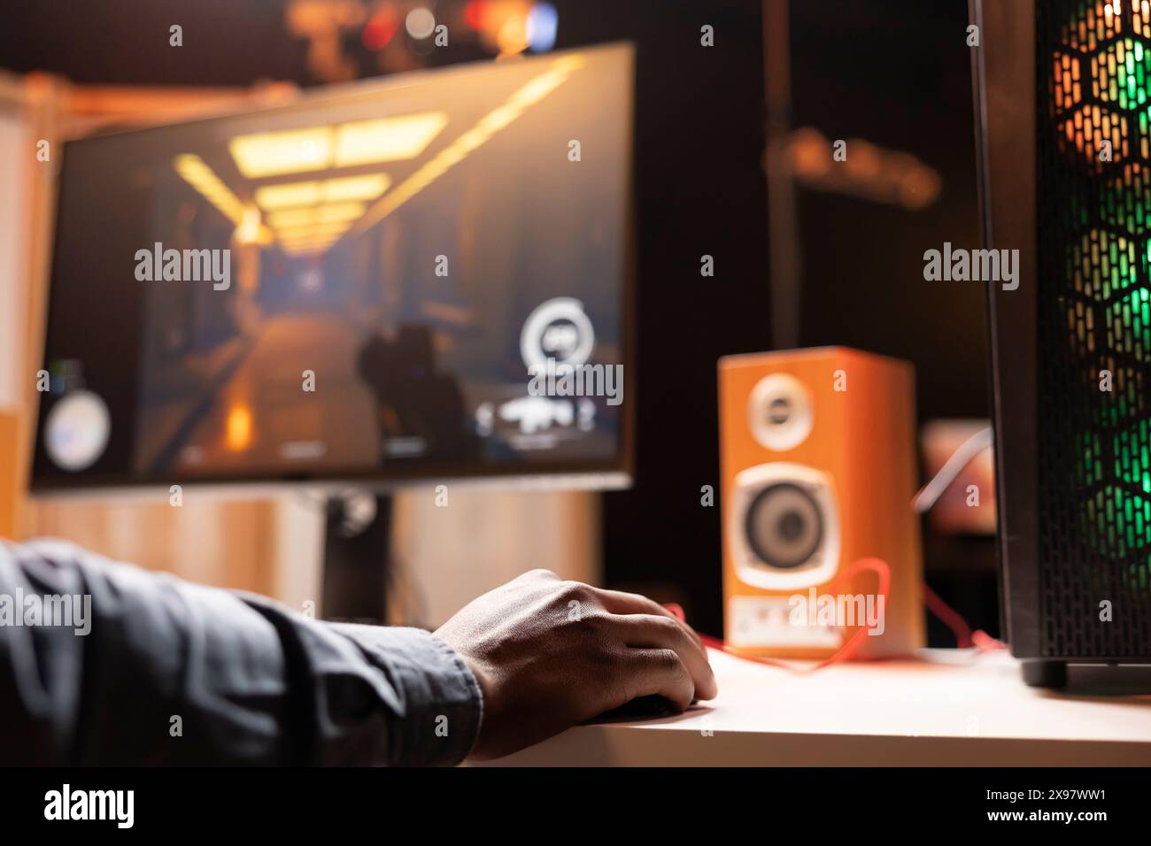 Man in living room playing video games on gaming PC at computer desk ...