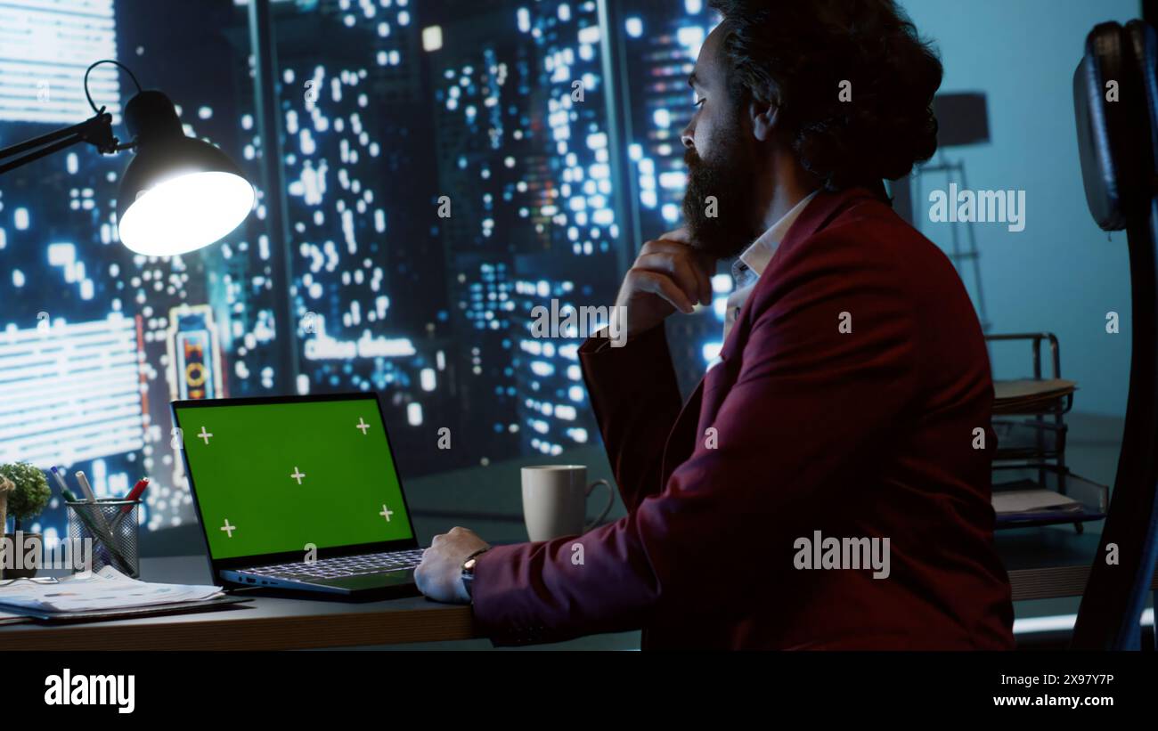 Company CEO works with laptop and greenscreen display, looking to grow ...