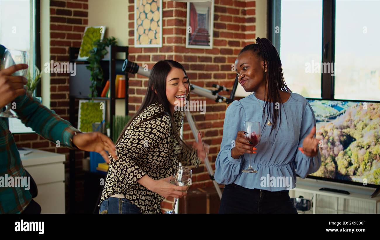 Multicultural friends dancing drinking on hi-res stock photography and ...