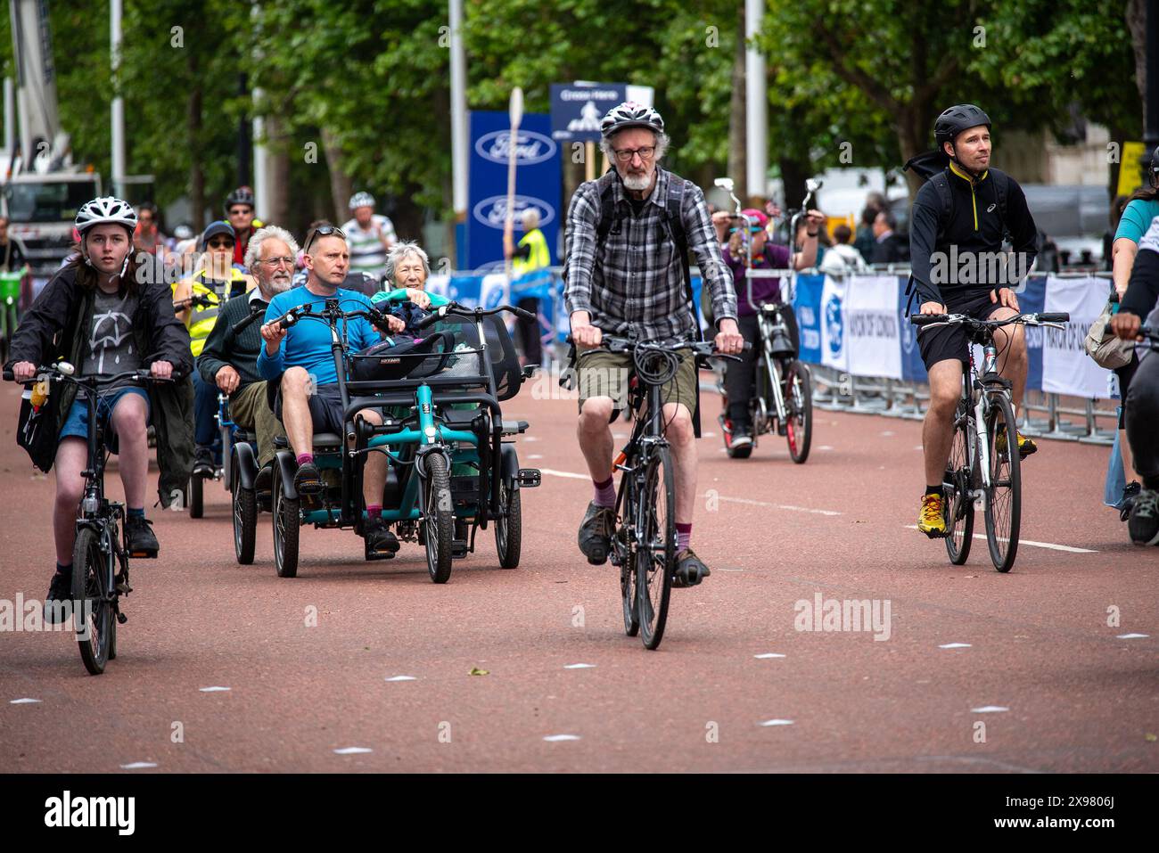 London, UK. 26th May, 2024. Cyclists ride through The Mall in London ...