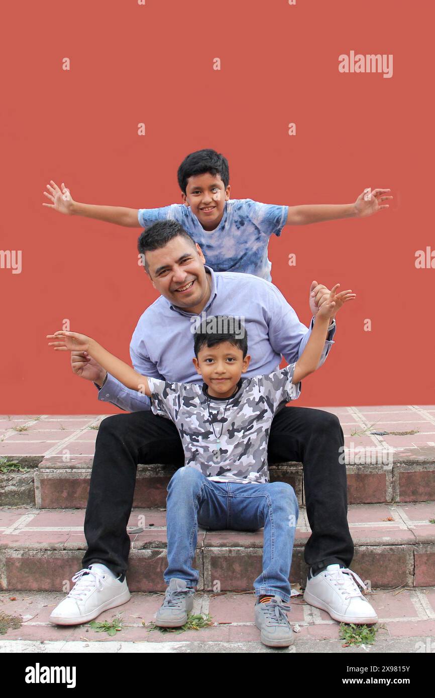 Divorced single dad plays with his two dark-skinned Latino children ...