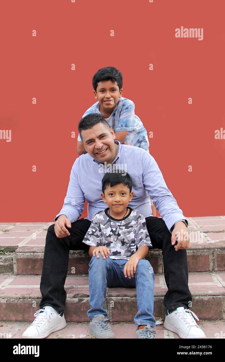 Divorced single dad plays with his two dark-skinned Latino children ...