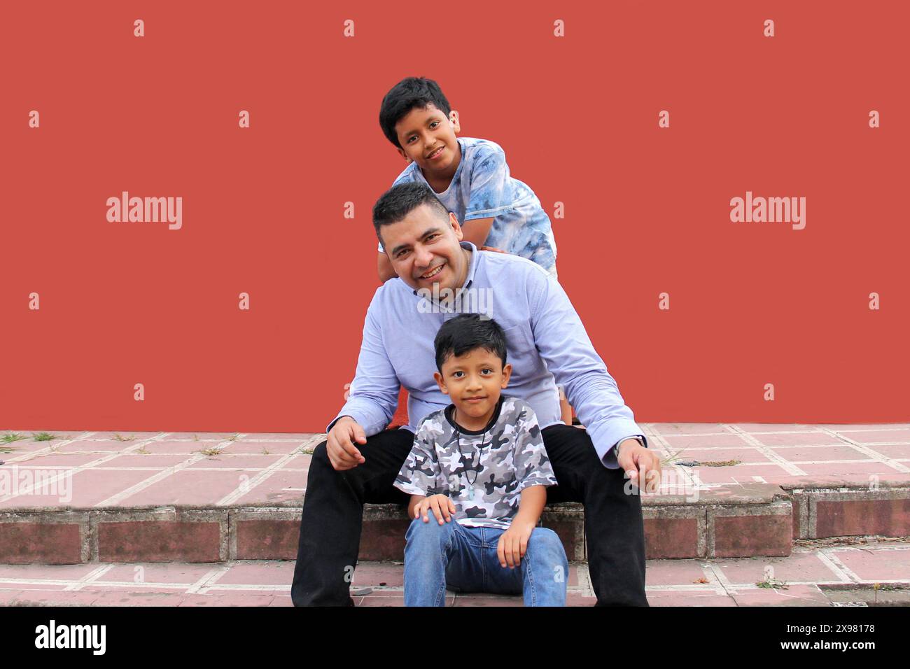 Divorced single dad plays with his two dark-skinned Latino children ...