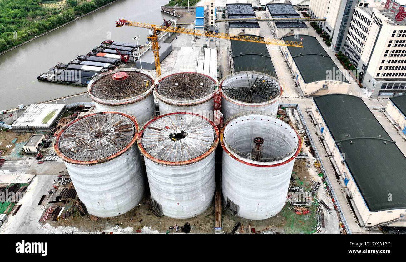 NANTONG, CHINA - MAY 27, 2024 - Builders work on a grain storage warehouse lifting tower in ...
