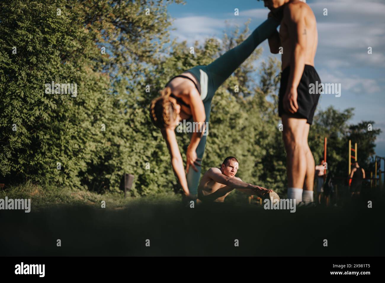 Outdoor acrobatic workout with a group practicing handstands and ...