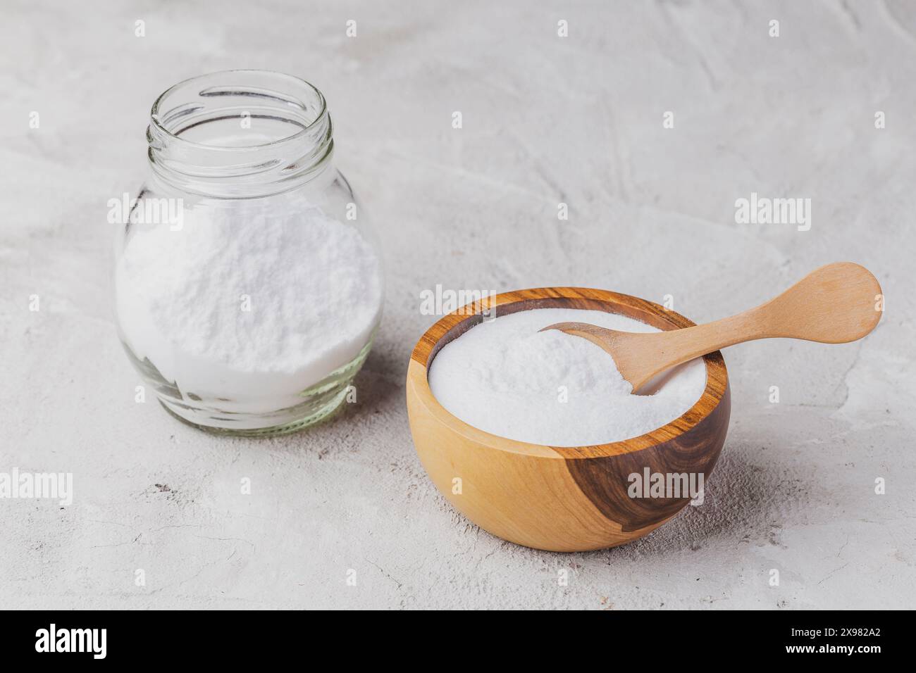 Baking soda in wooden container on rustic surface Stock Photo - Alamy