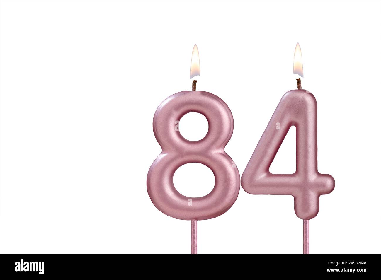 Lit birthday candle - Candle number 84 on white background Stock Photo ...