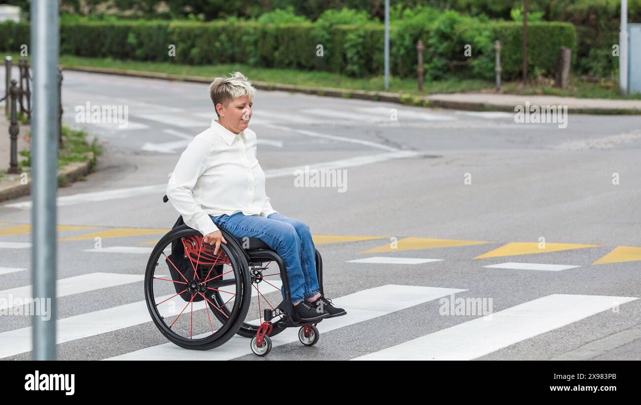 Woman with disability on a wheelchair on the city street Stock Photo ...