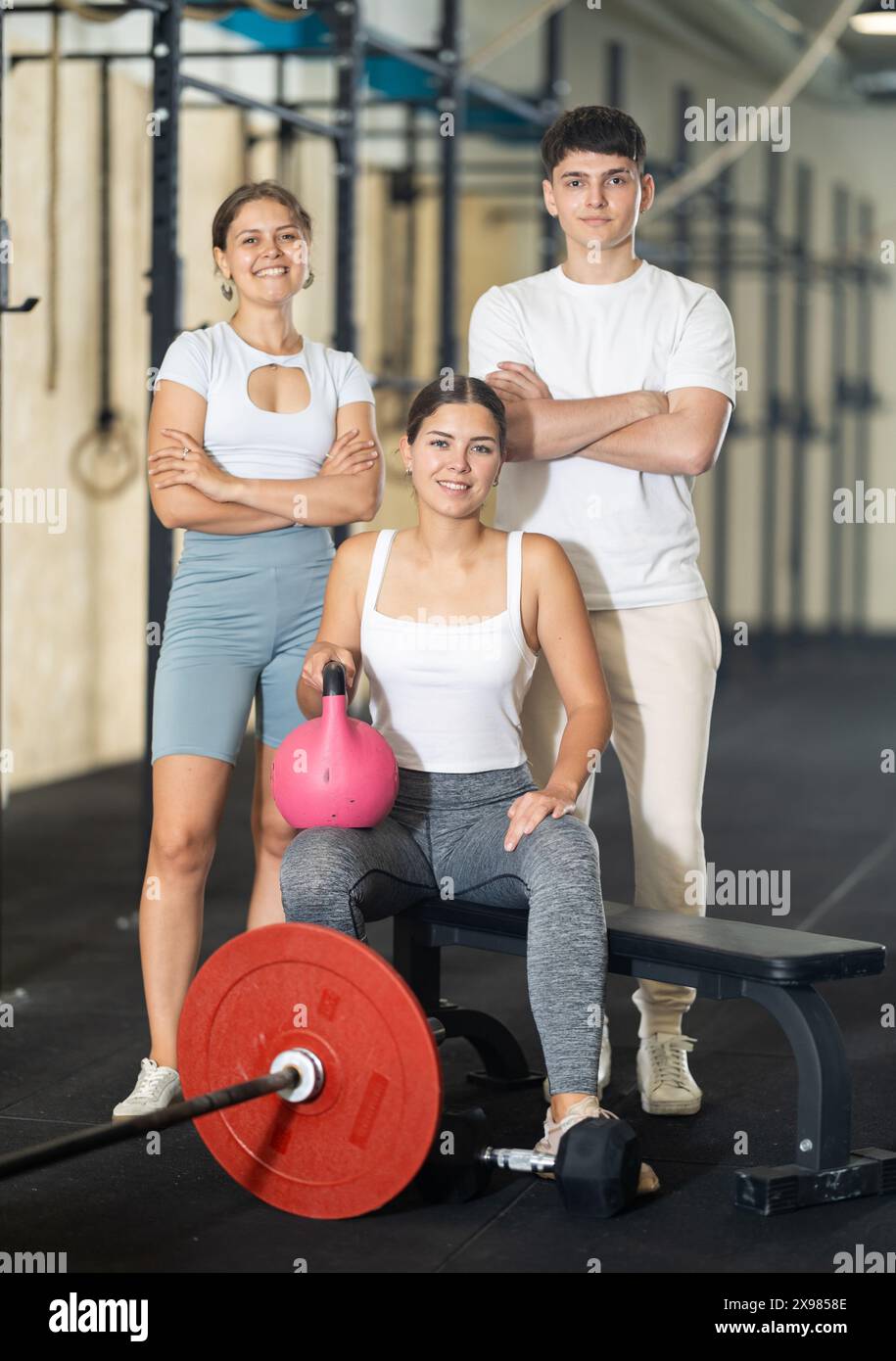Portrait of three positive athletes in modern crossfit gym Stock Photo ...