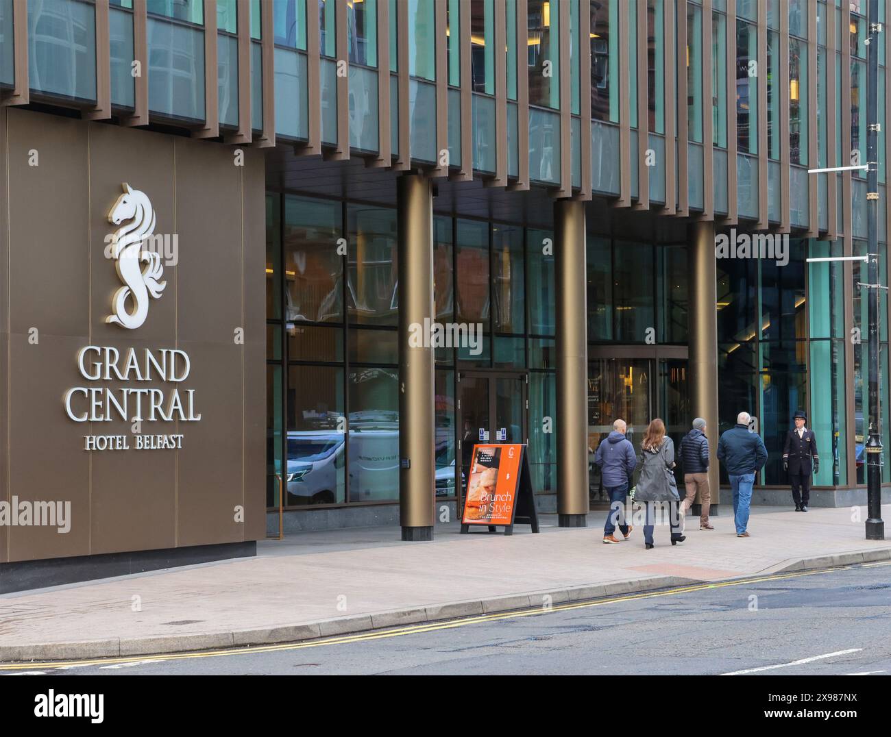 Main entrance Grand Central Hotel Belfast pedestrians walking past ...