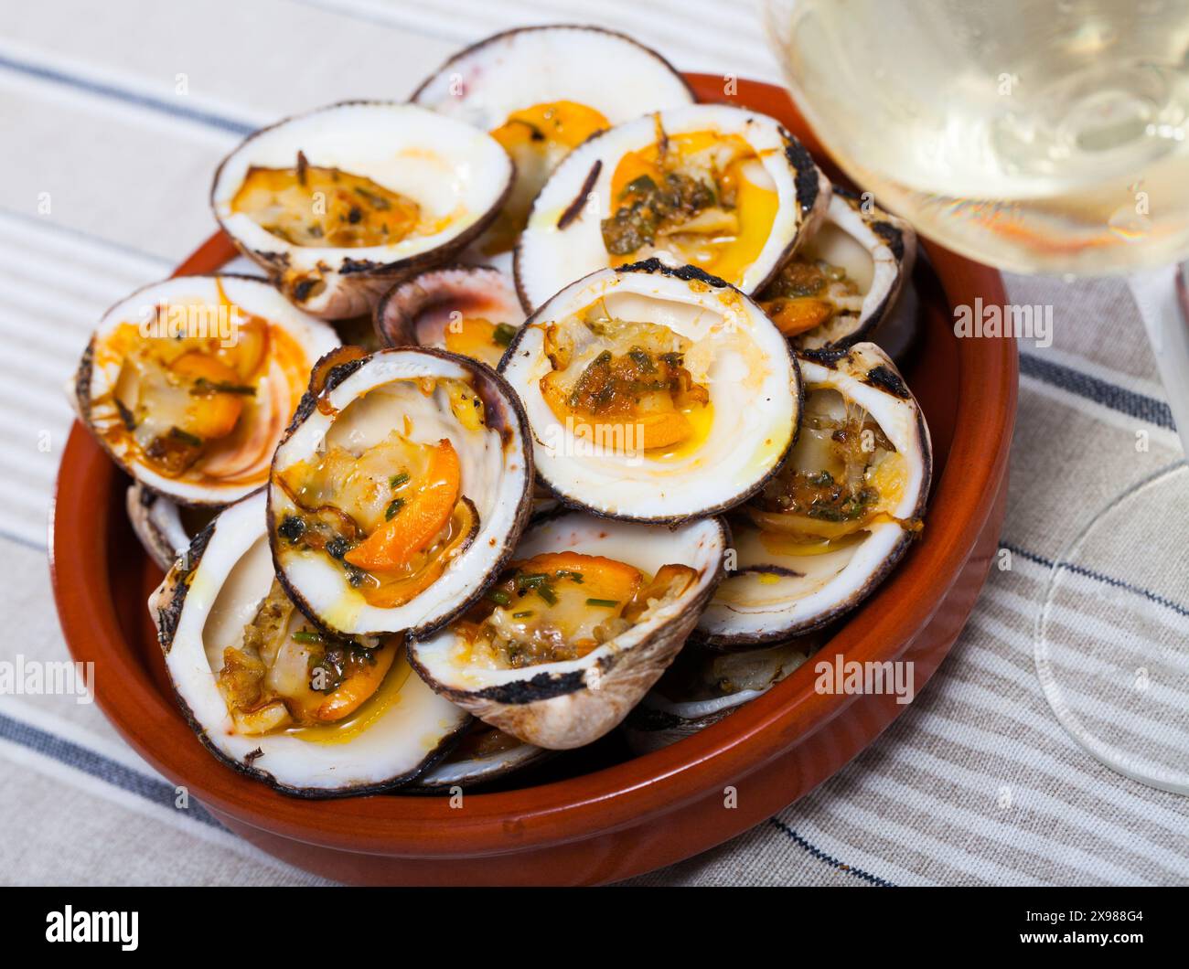 Baked in oven with sauce open seashell served at white plate Stock ...