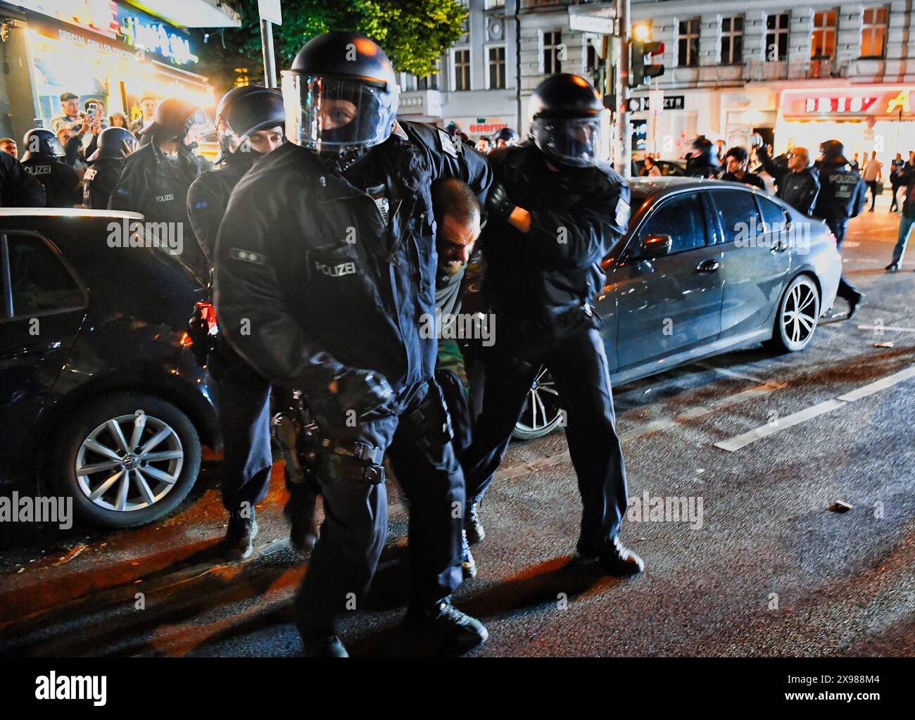 29 May 2024, Berlin: Police officers take a man into custody on ...