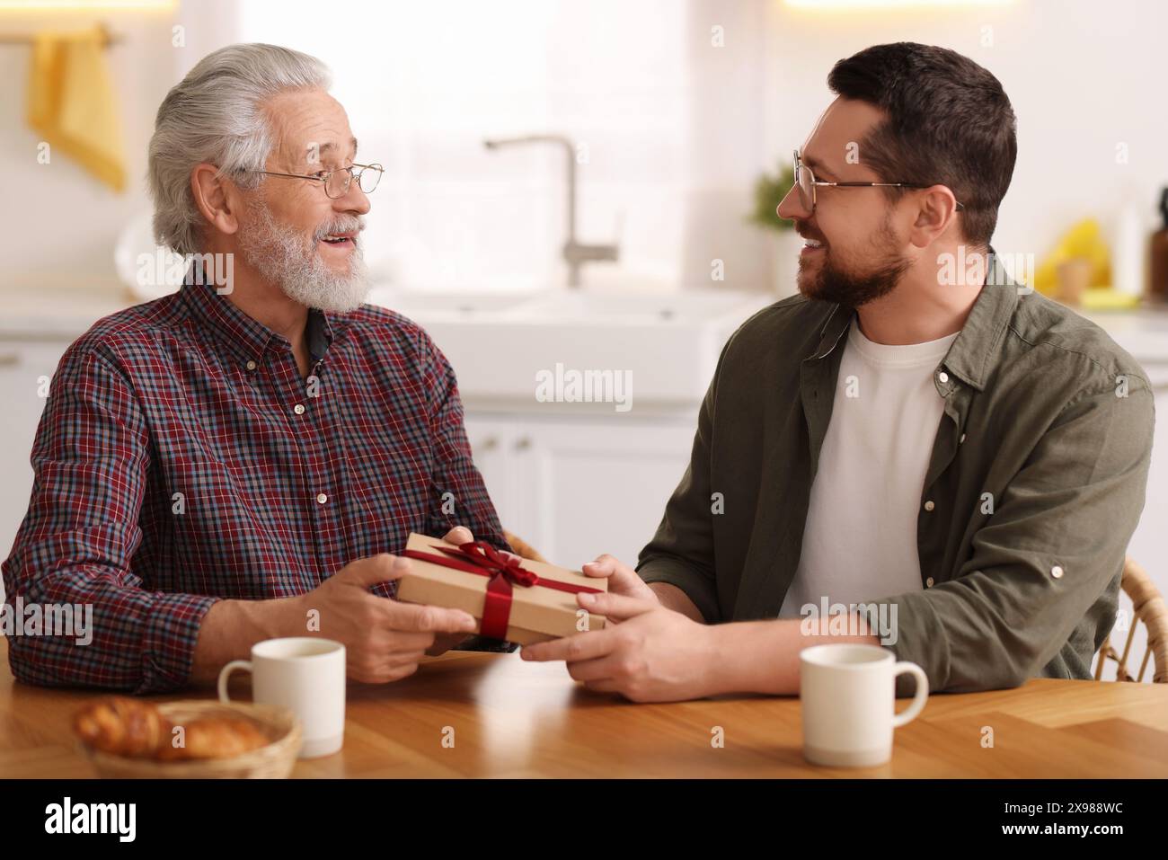 Father son giving present hi-res stock photography and images - Alamy