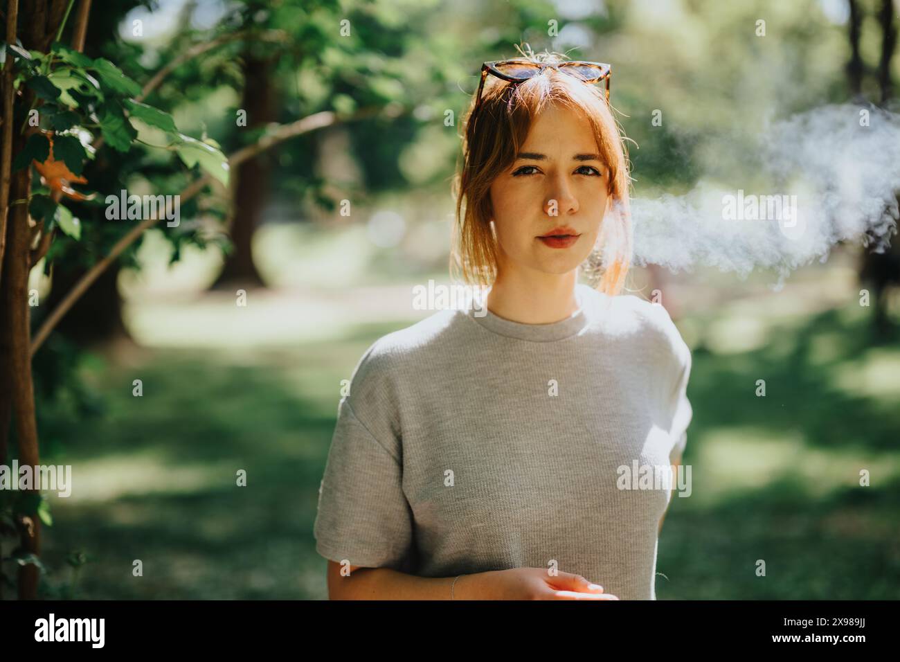 Young woman exhaling smoke hi-res stock photography and images - Alamy