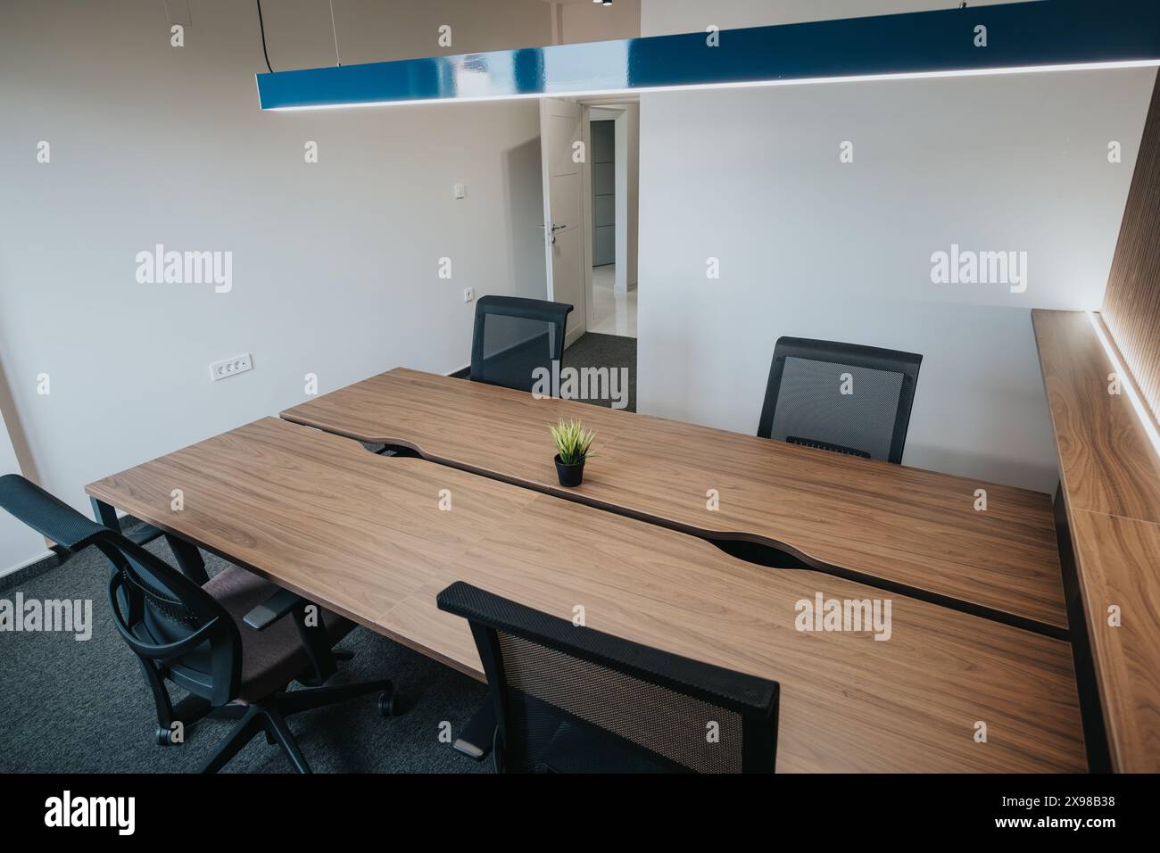 Modern office conference room with stylish furniture and blue lighting ...