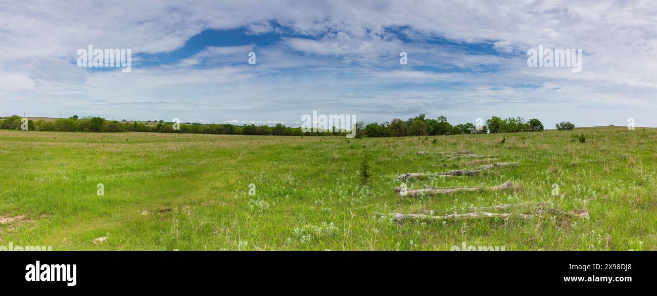 Open farmland, Aurora, Kansas. Green fields; cloudy blue sky above ...