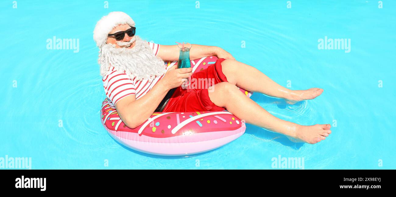 Santa Claus relaxing on inflatable ring in swimming pool Stock Photo ...
