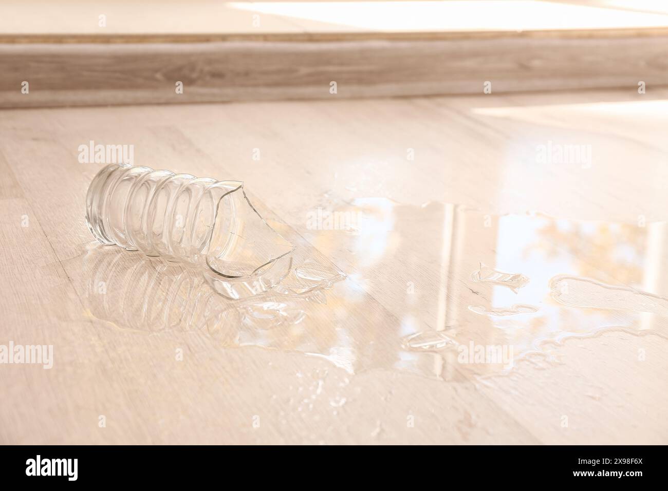 Wooden laminate floor with spilled water and shattered vase Stock Photo ...