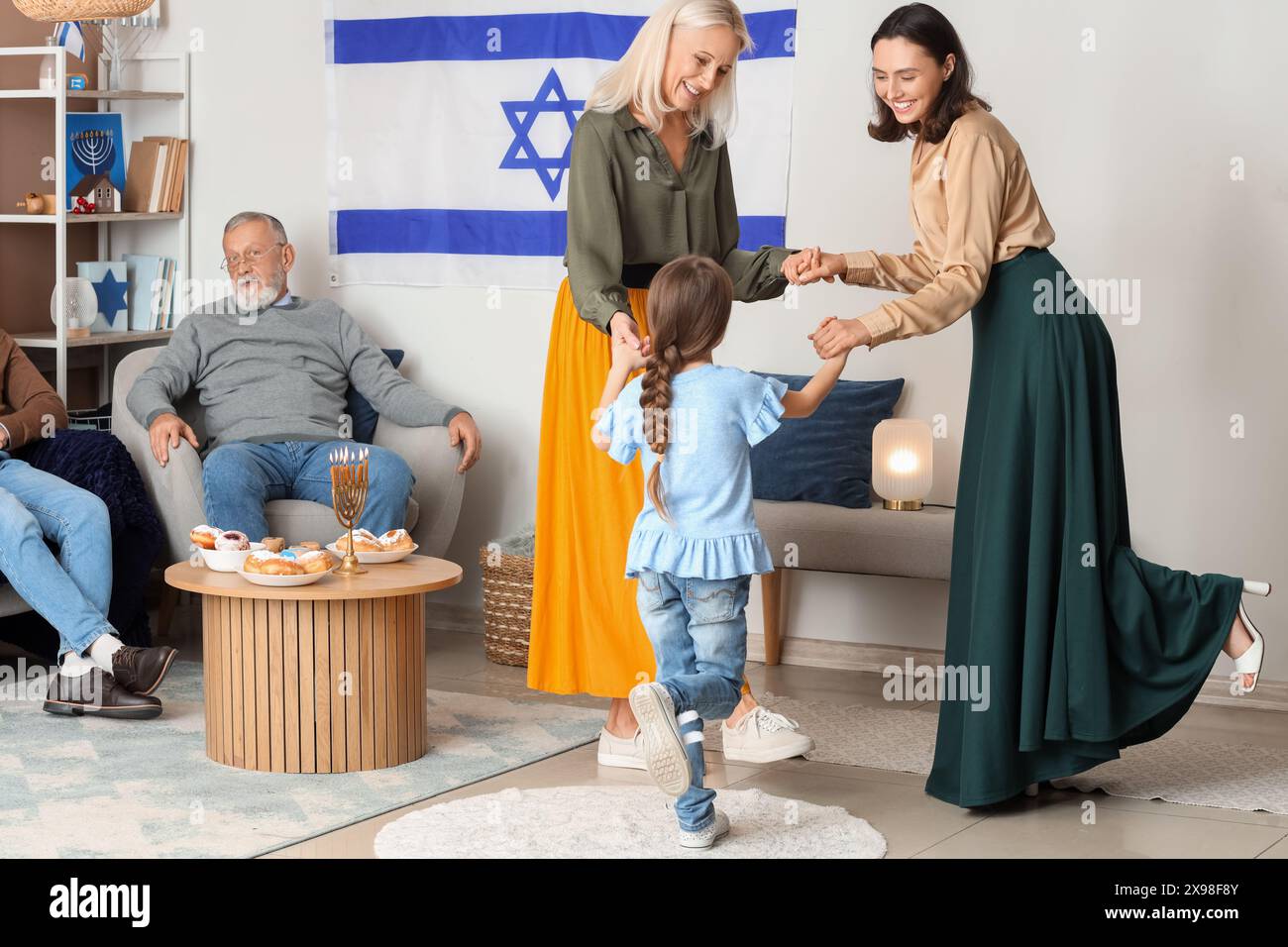 Happy Jewish family celebrating Hanukkah at home Stock Photo - Alamy