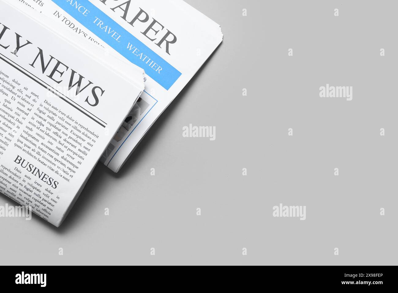 Different newspapers on grey background Stock Photo - Alamy