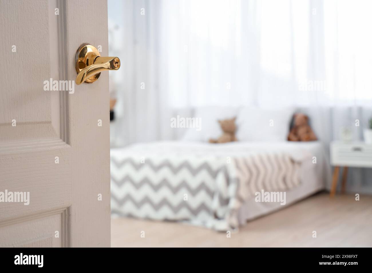 View of modern children's room with toys through open door Stock Photo ...