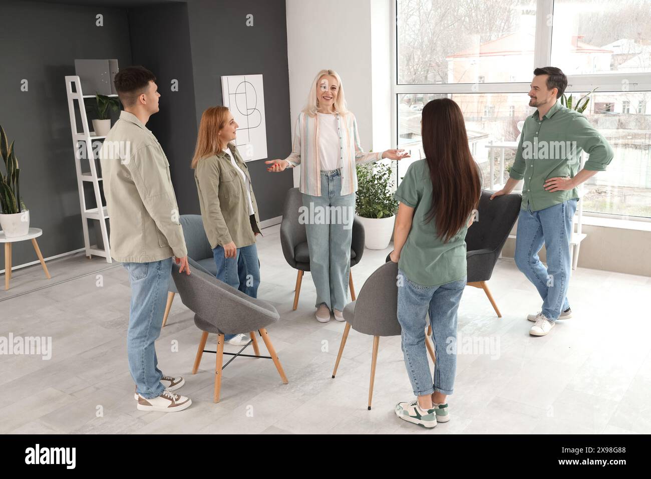 Female psychologist with people at group therapy session Stock Photo ...