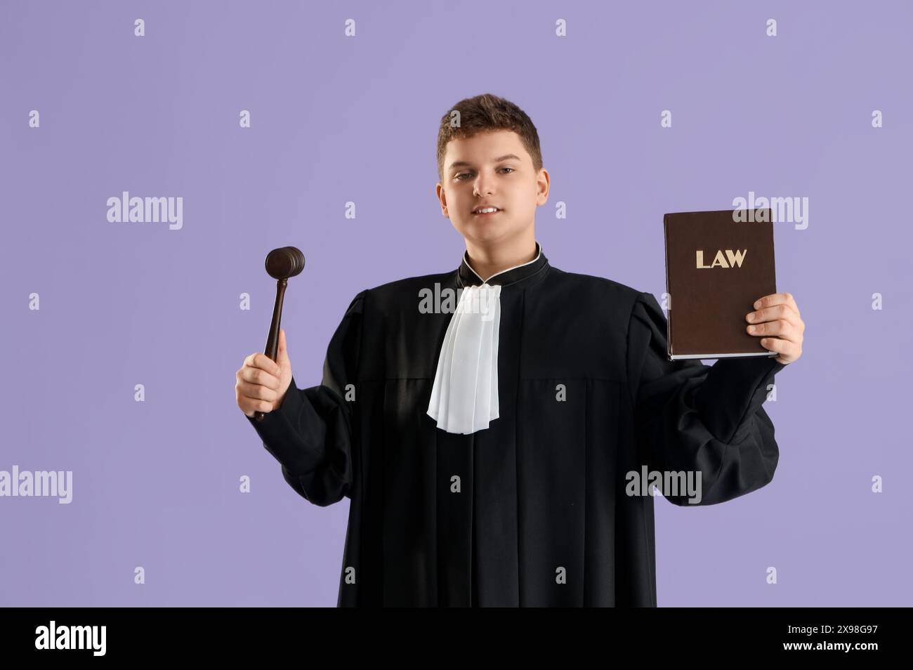 Teenage judge with law book and gavel on lilac background Stock Photo ...