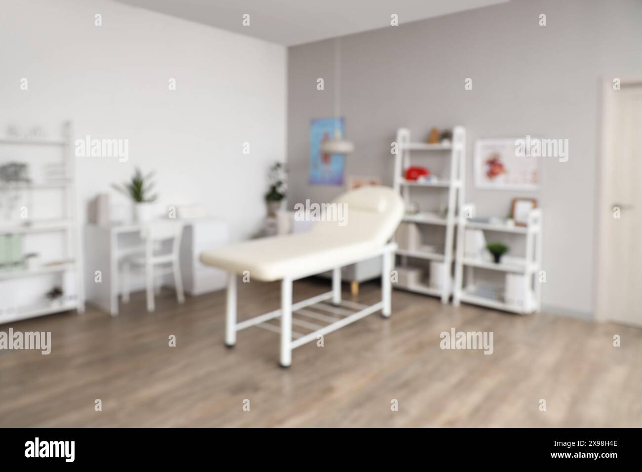 Blurred view of medical office with couch, doctor's workplace and sofa ...