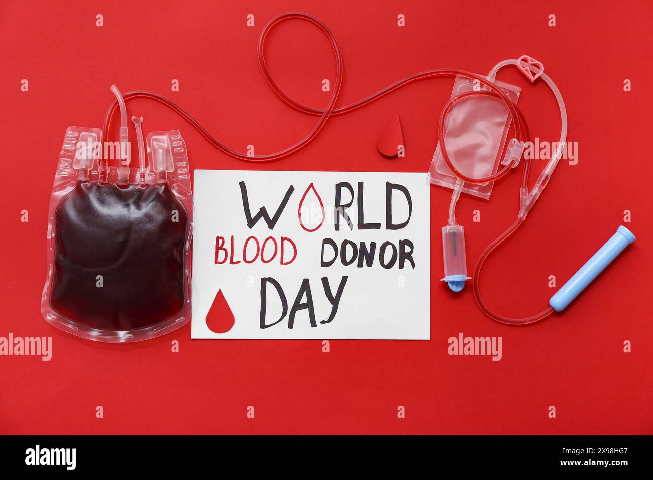 Equipment for blood transfusion and paper sheet with text WORLD BLOOD ...