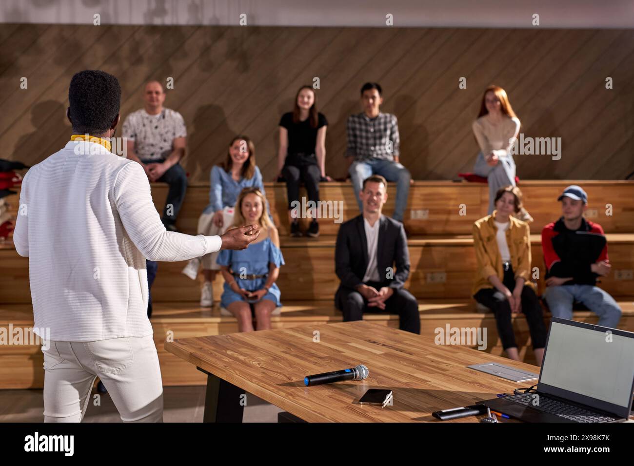 afro male lecturer communicating with adult students, giving necessary ...