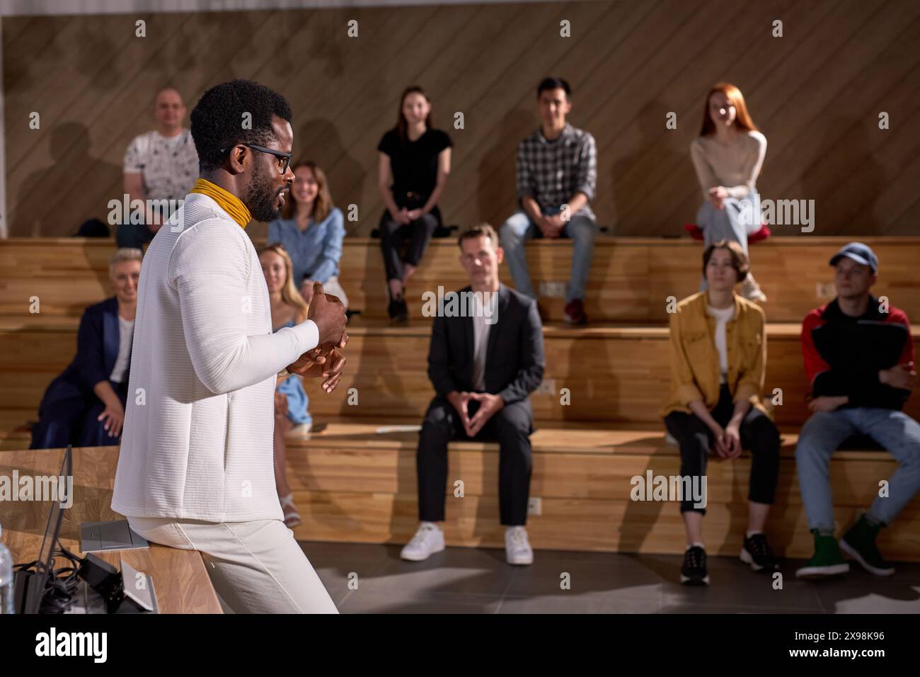 male african-american speaker giving presentation in lecture hall ...