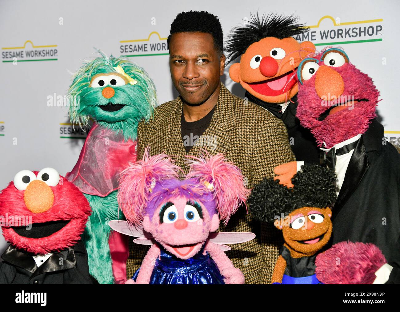Leslie Odom Jr., center, poses with Muppet characters at the Sesame ...