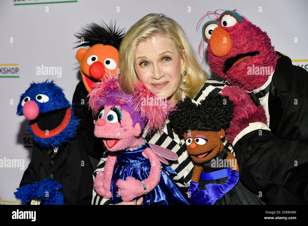 Diane Sawyer, center, poses with Muppet characters at the Sesame ...