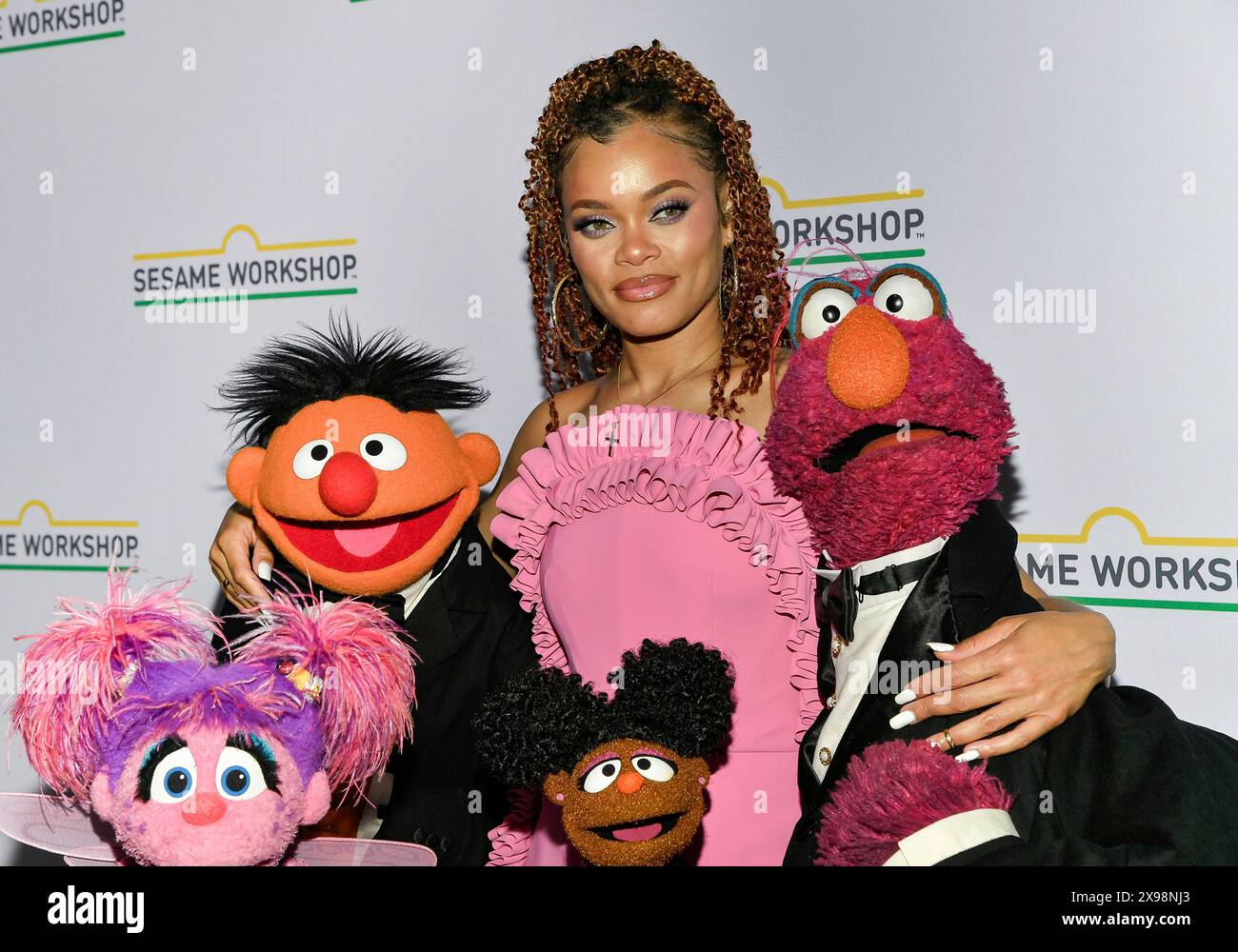 Andra Day, center, poses with Muppet characters at the Sesame Workshop ...
