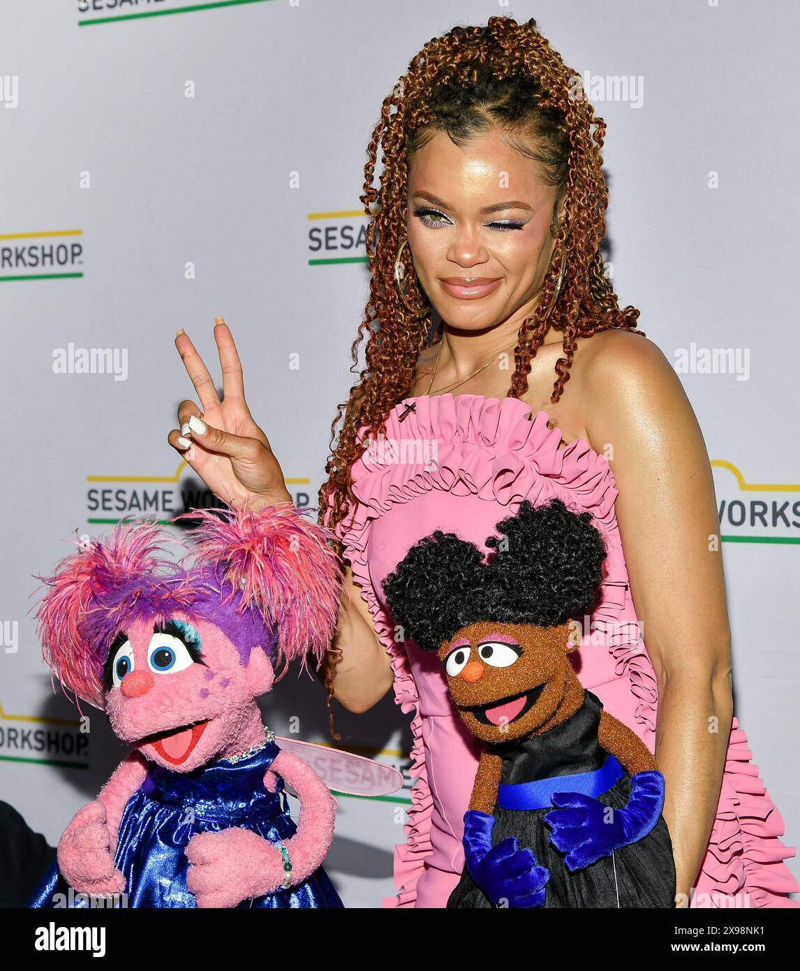 Andra Day, center, poses with Muppet characters at the Sesame Workshop ...