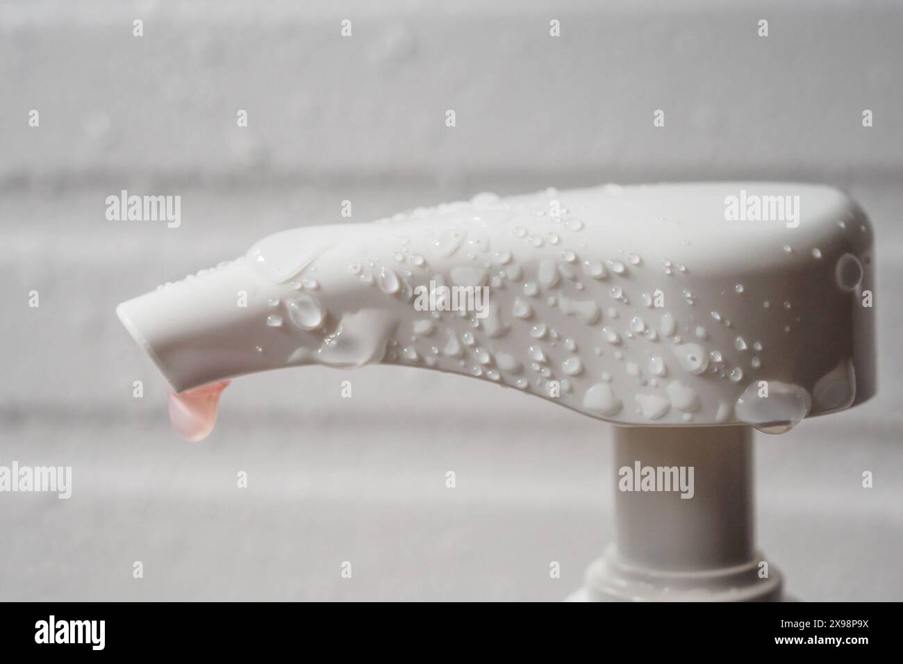 Water drop on liquid soap dispenser pump during bath time Stock Photo ...