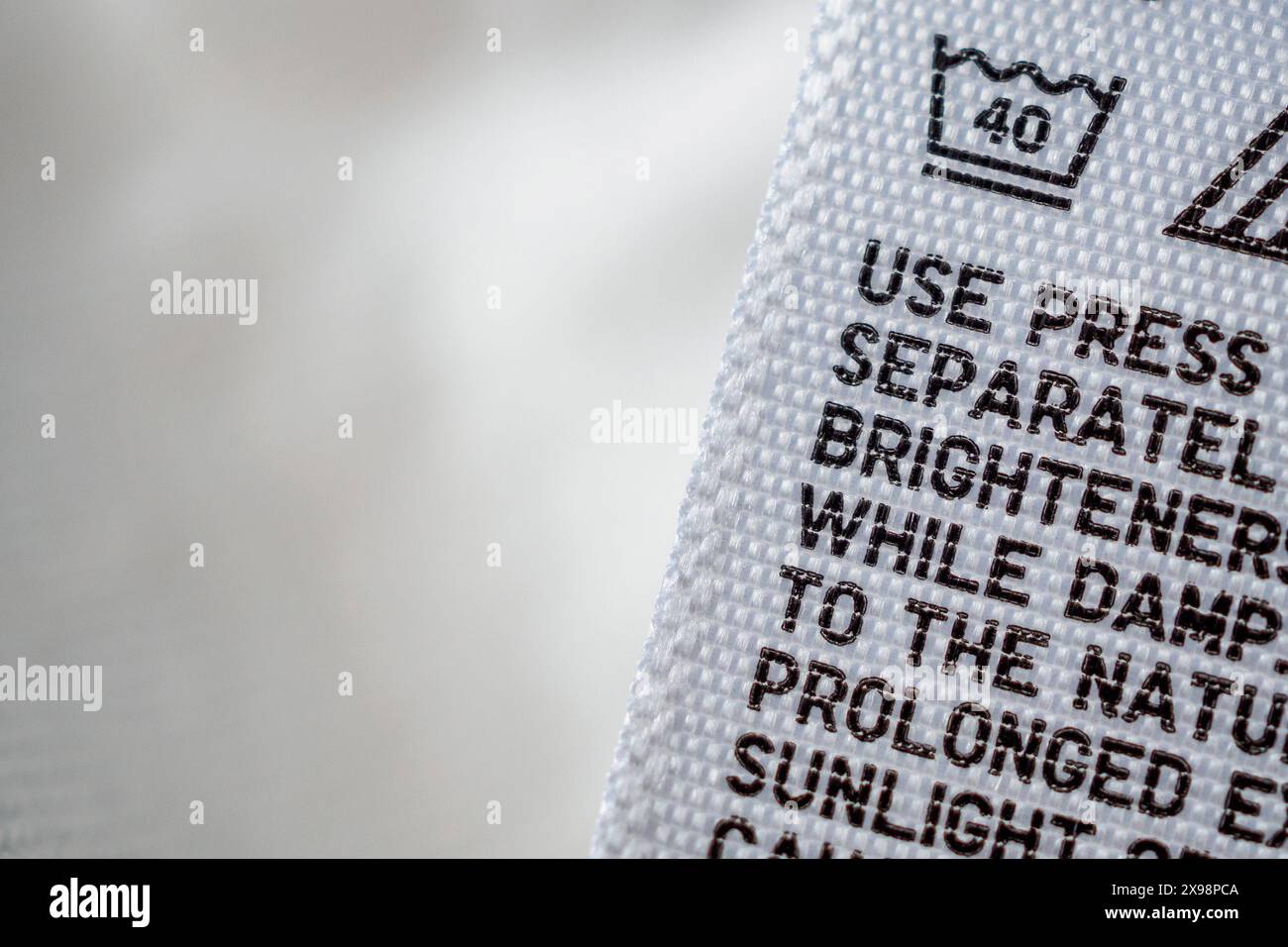 Cloth label tag with laundry care instructions Stock Photo - Alamy