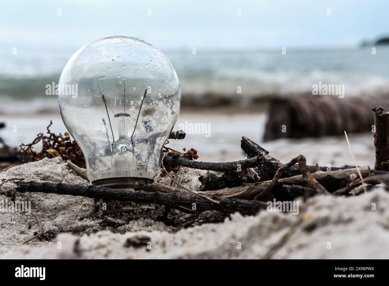 broken light bulb on the beach Stock Photo - Alamy