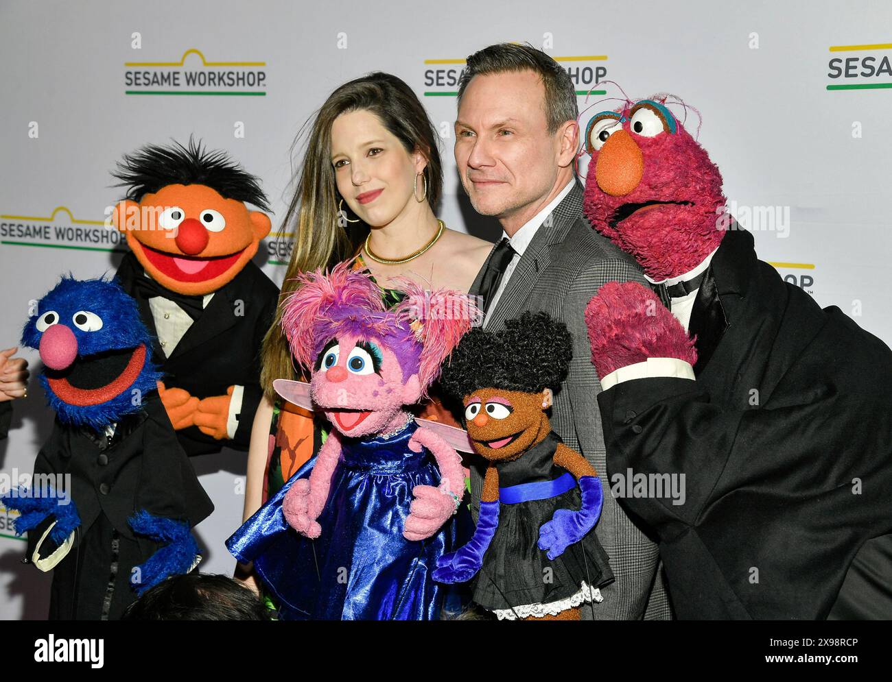 Christian Slater, center right, and wife Brittany Lopez pose with ...