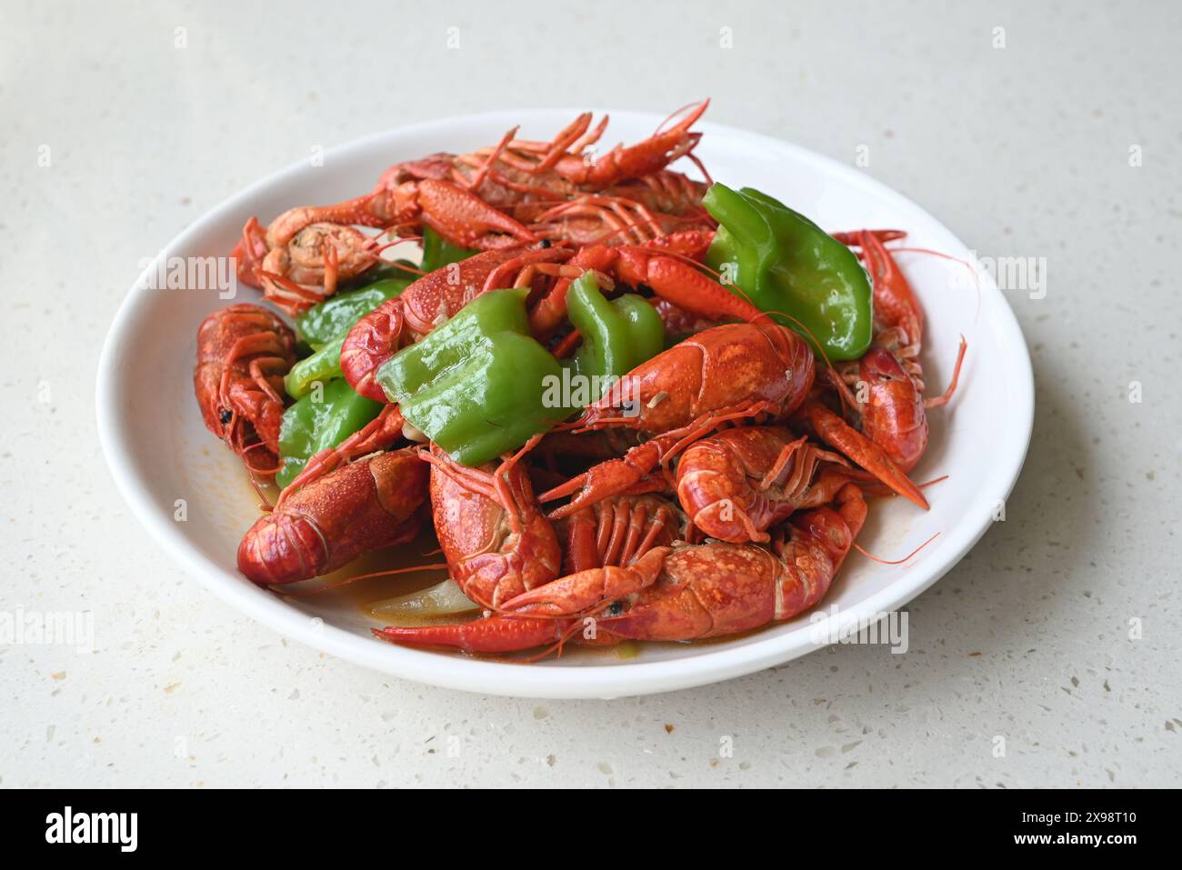 red crayfish with green peppers on a plate for eating Stock Photo - Alamy