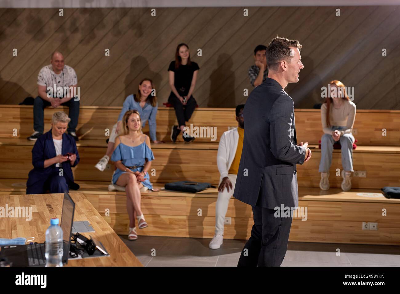 Side view caucasian male speaker in formal suit giving talk on ...