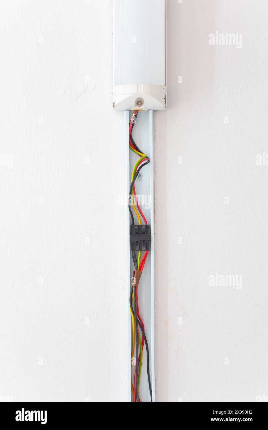 Exposed colourful cables on electrical wire casing base for rewiring ...