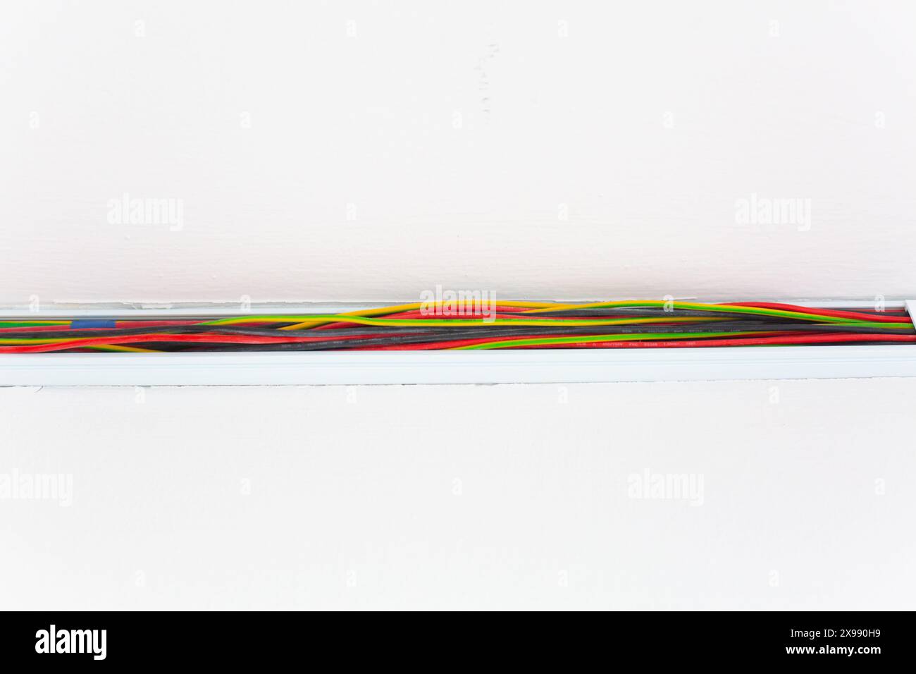 Exposed Colourful Cables On Electrical Wire Casing Base For Rewiring Purpose Is Layout Neatly On