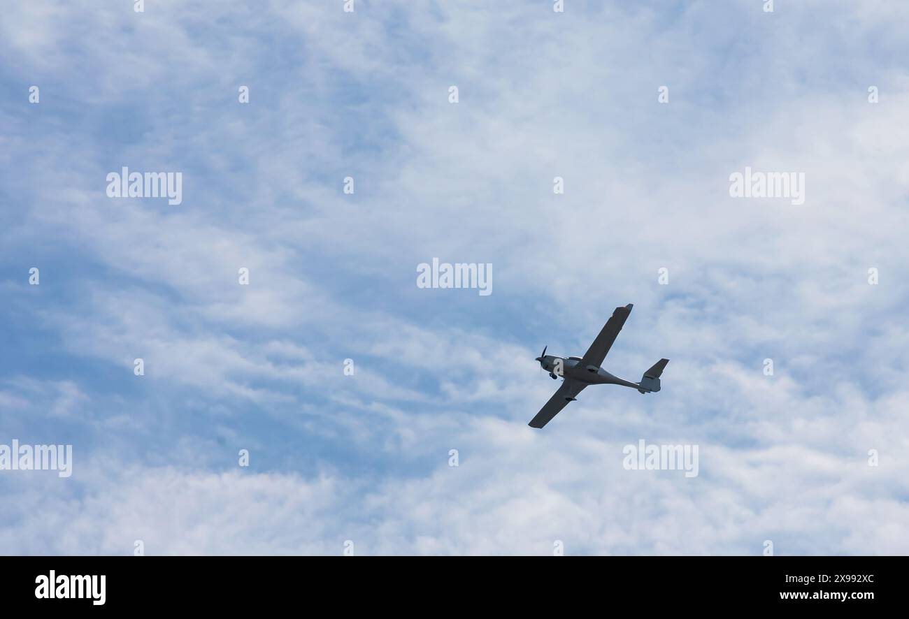 small plane flying low in the sky with space for text Stock Photo - Alamy