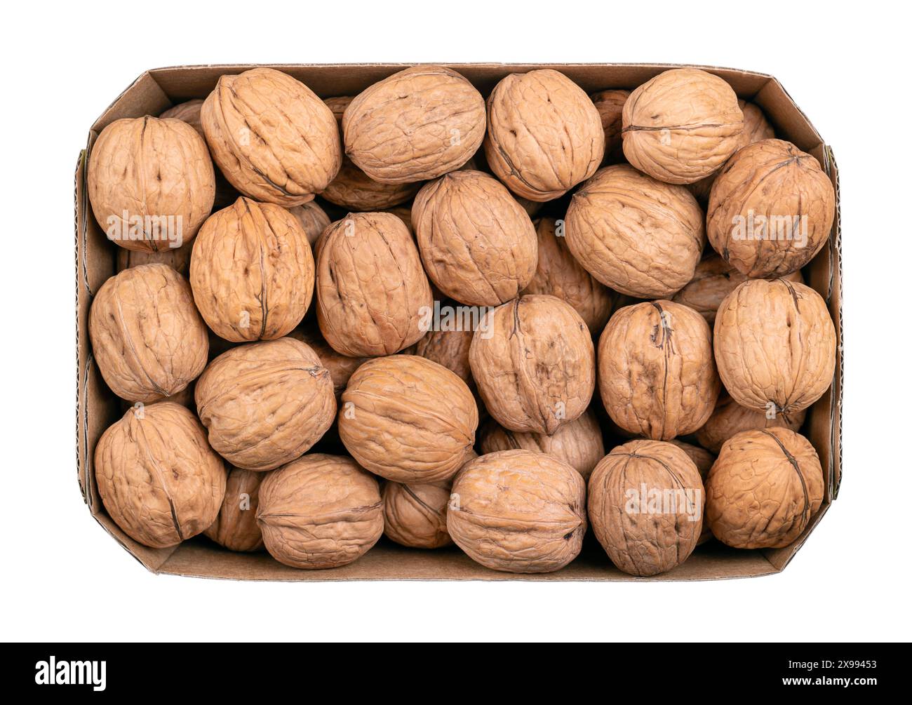 Walnuts in their shells, in a cardboard punnet. Unshelled dried seeds ...