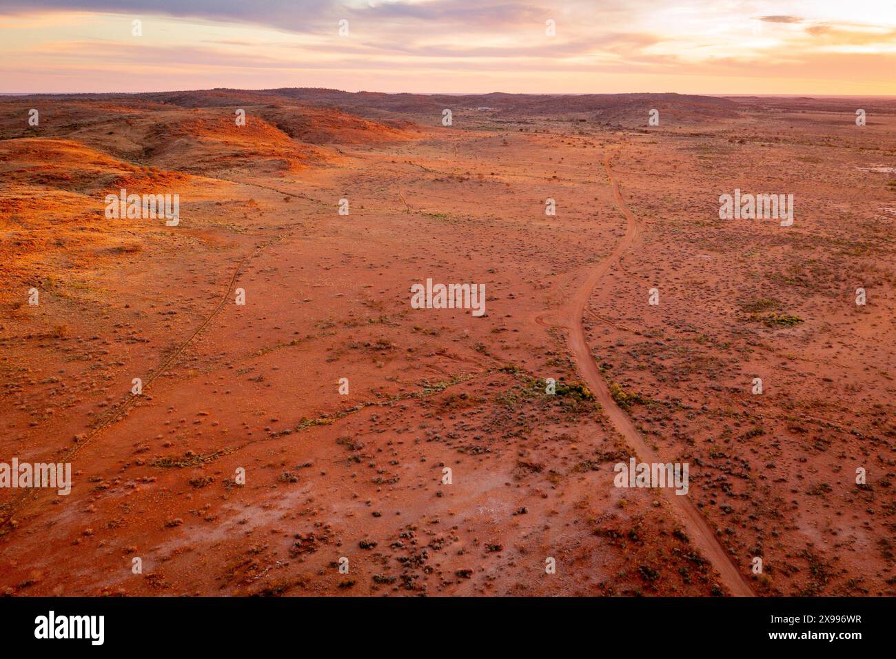 Aerial view of barren red plains under a sunset sky at Broken Hill in ...