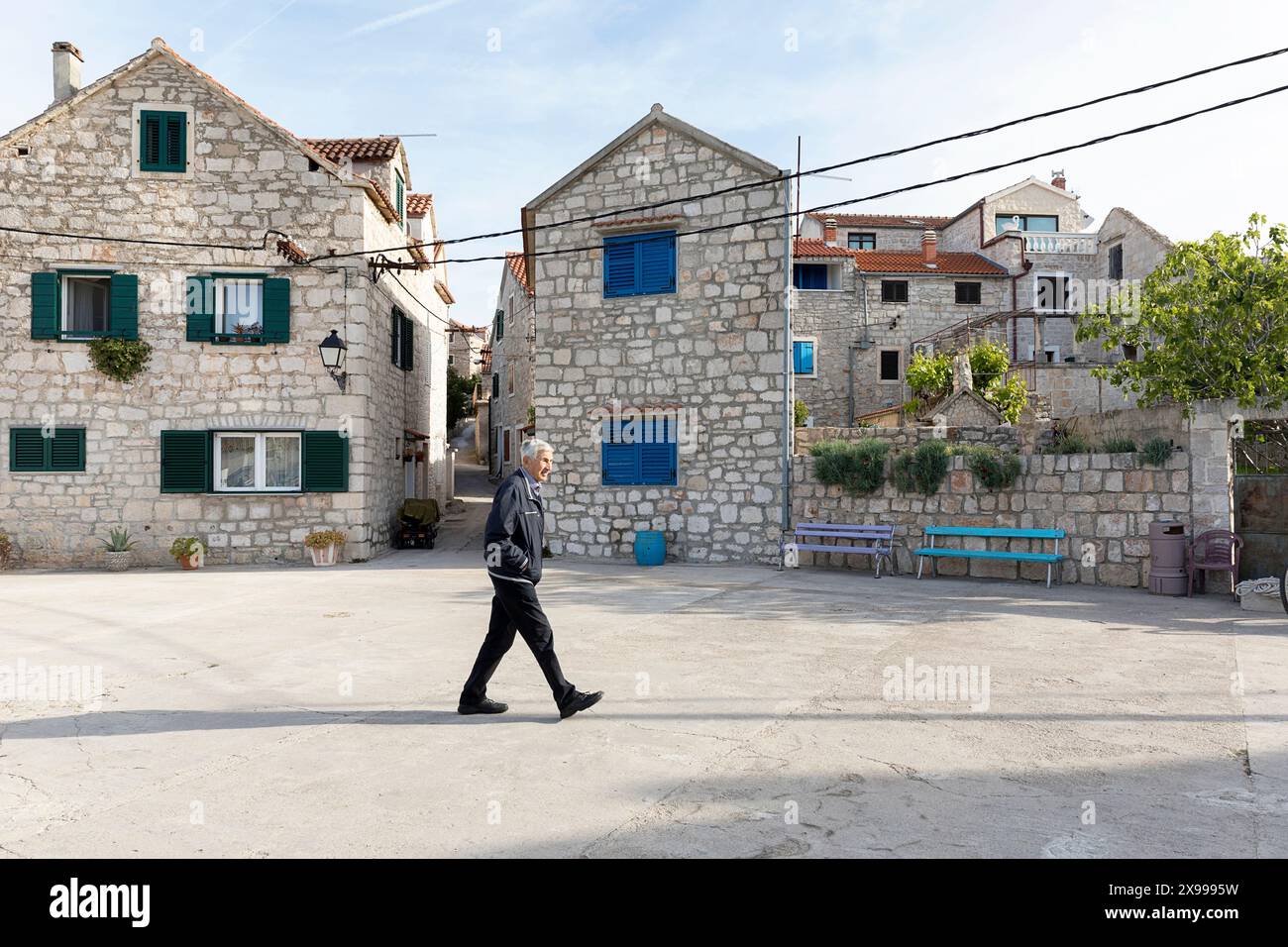 Local man infront of old traditional houses in a small picturesque ...