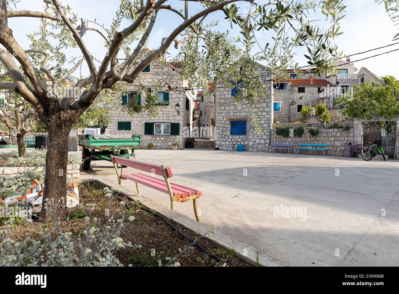 Colourful benches and Traditional old stone houses in a small ...