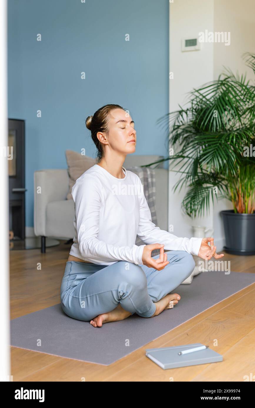 Young mindful woman meditating home hi-res stock photography and images ...