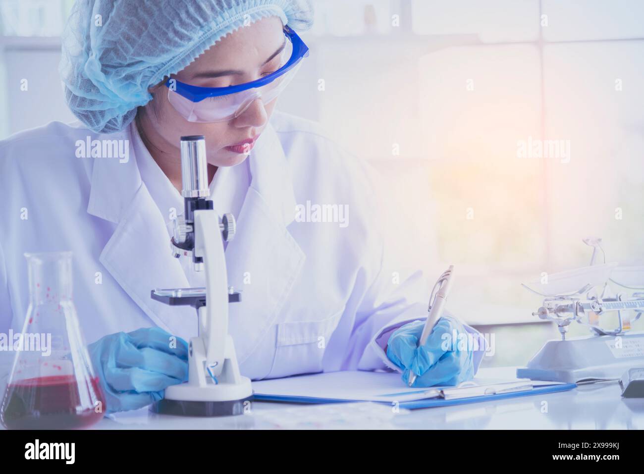 Female scientist look at microscope, science test tube analyse ...